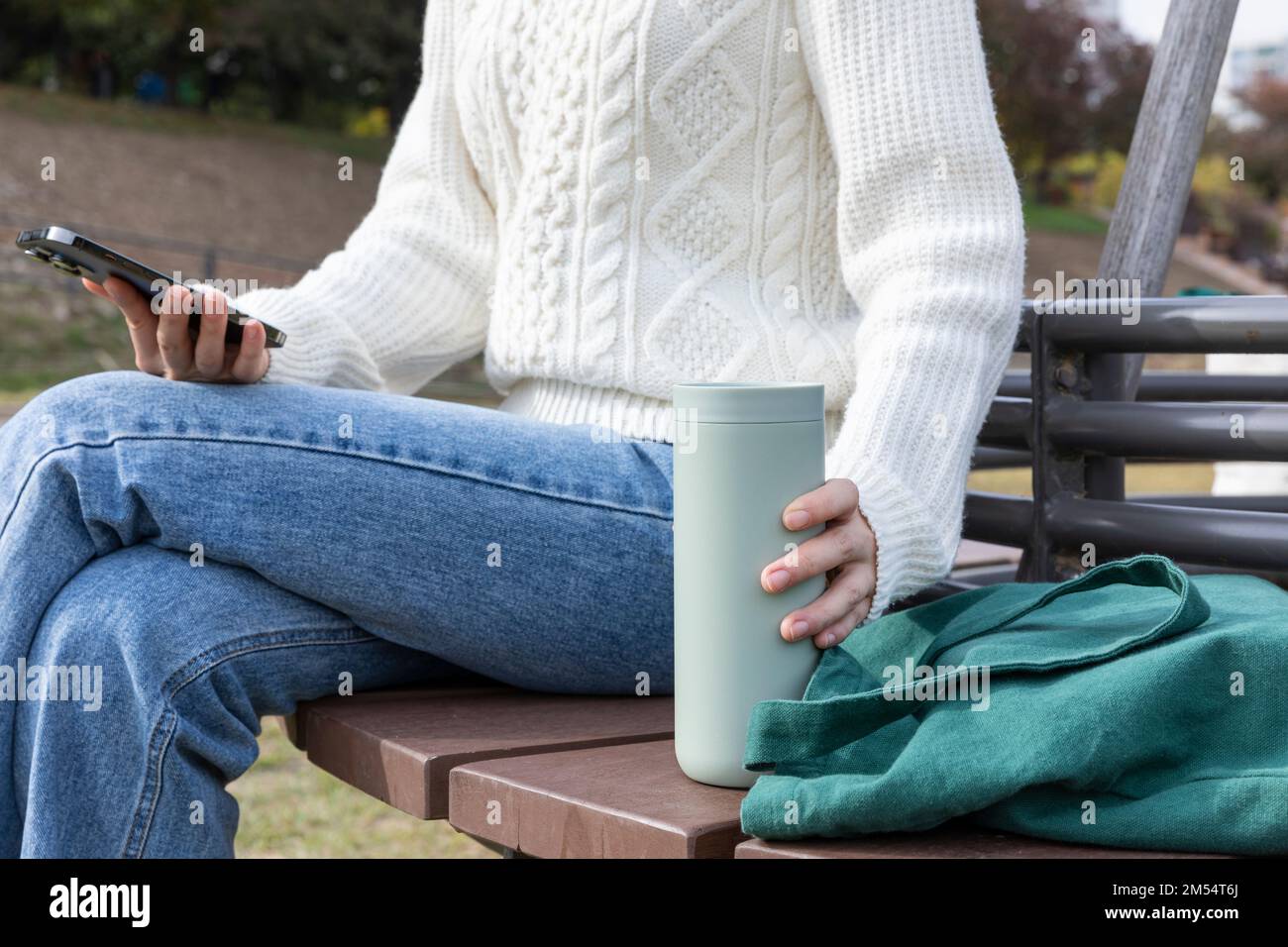 eco friendly habits hand gesture using tumbler and cellphone Stock ...