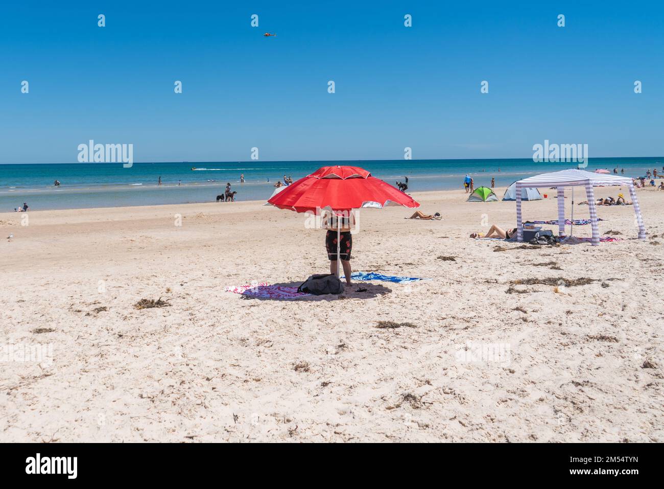 Adelaide, Australia. 26 December 2022.A woman sheltering under a ...