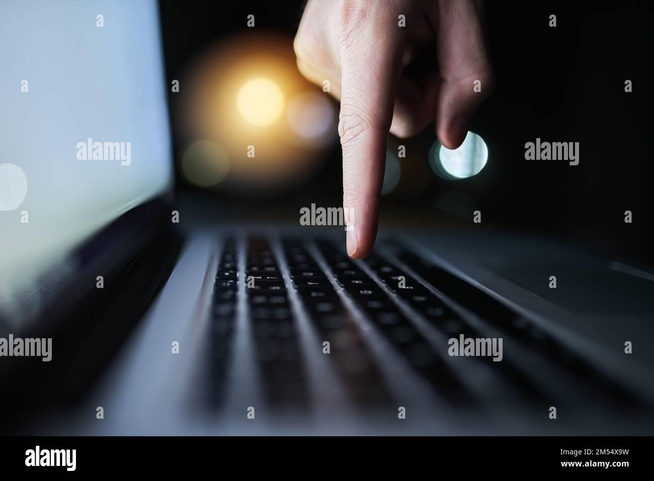 One key at a time. an unrecognizable computer hacker using a laptop ...