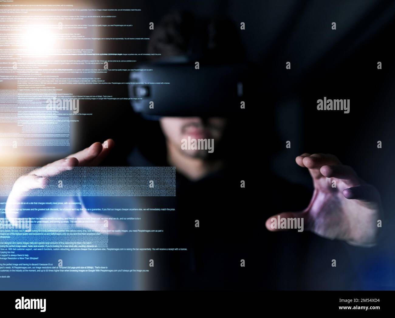 Technology made tangible. a young computer programmer wearing a vr headset while working on his ...