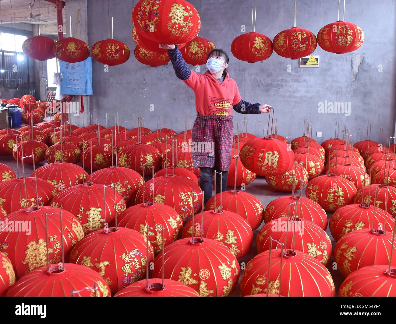 A worker is drying red lanterns in a workshop in Shuangfeng High tech ...
