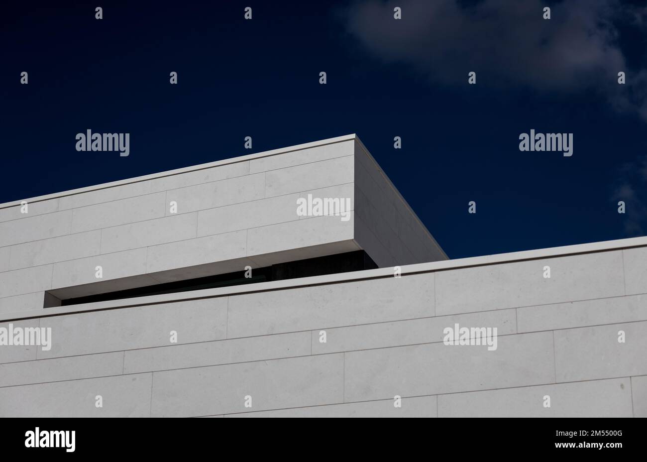 building against the blue sky with white clouds. Modern structures ...