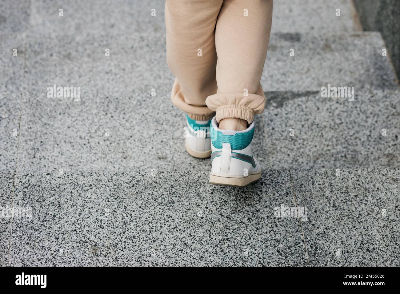 Female legs in sneakers hi-res stock photography and images - Alamy