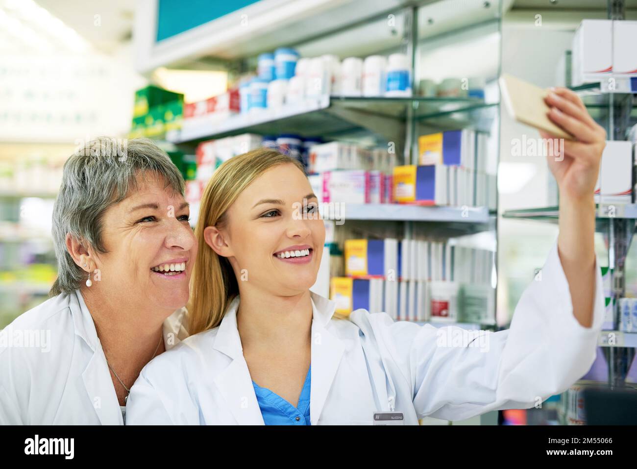 Celebrating team spirit with a selfie. two happy pharmacists taking a ...