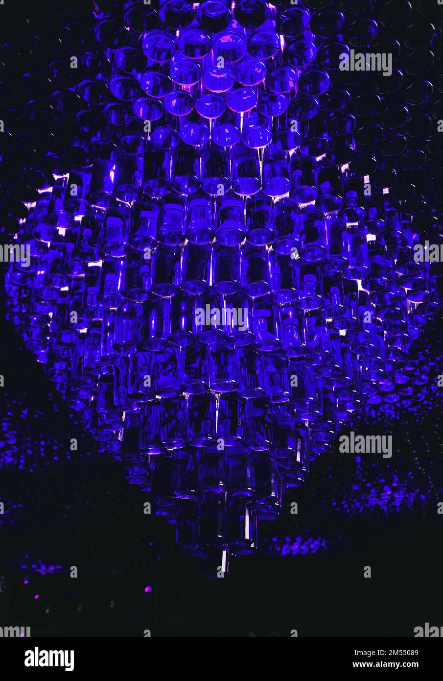 Light, design and interior. A group of blue lamps in the shape of wine ...