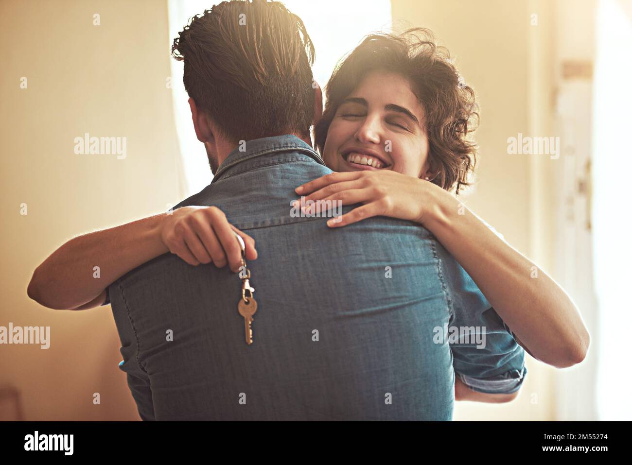 Finally, were homeowners. a happy young couple hugging as they move ...