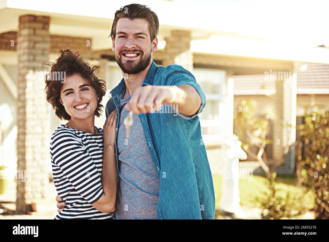 The perks of adulting. a happy young couple holding the keys to their ...