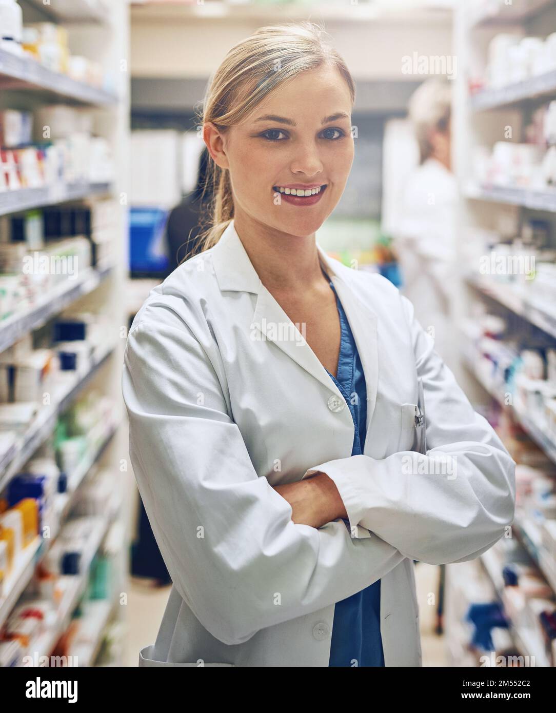 You dont need an appointment to see a pharmacist. Portrait of a pharmacist standing in a isle ...