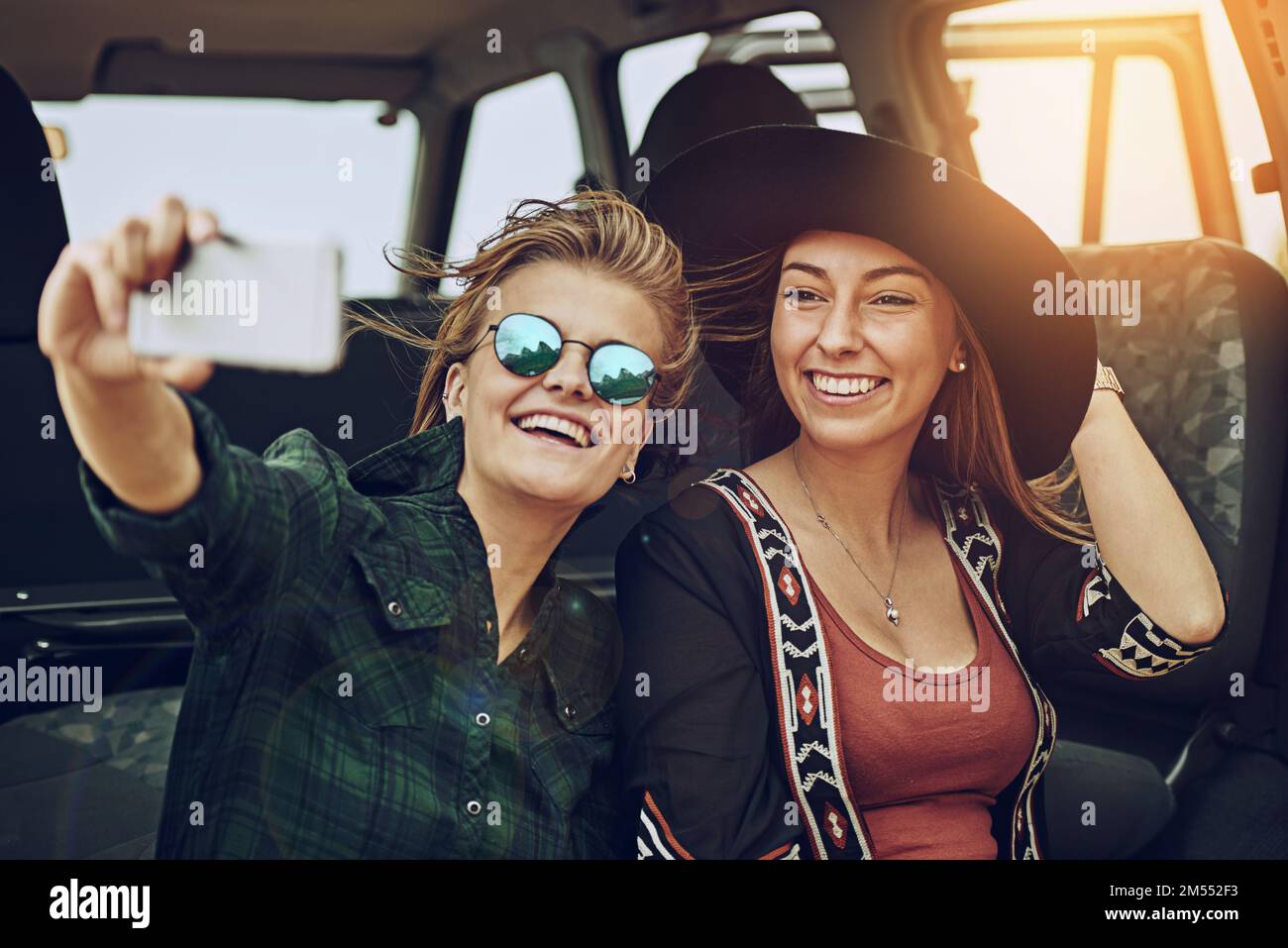 Making the best memories together. two young friends taking a selfie ...