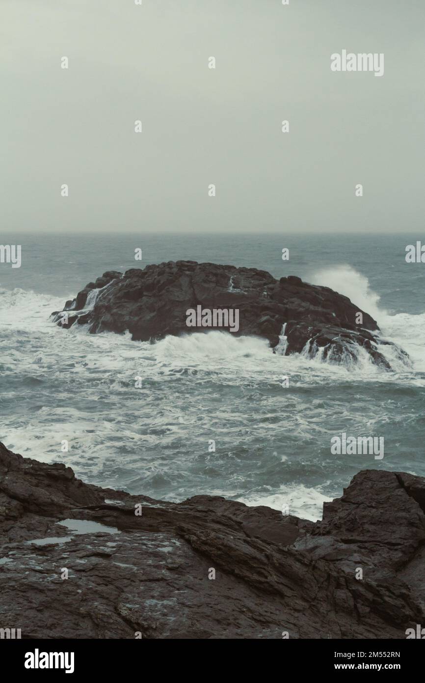 Large rock in cold sea landscape photo Stock Photo - Alamy