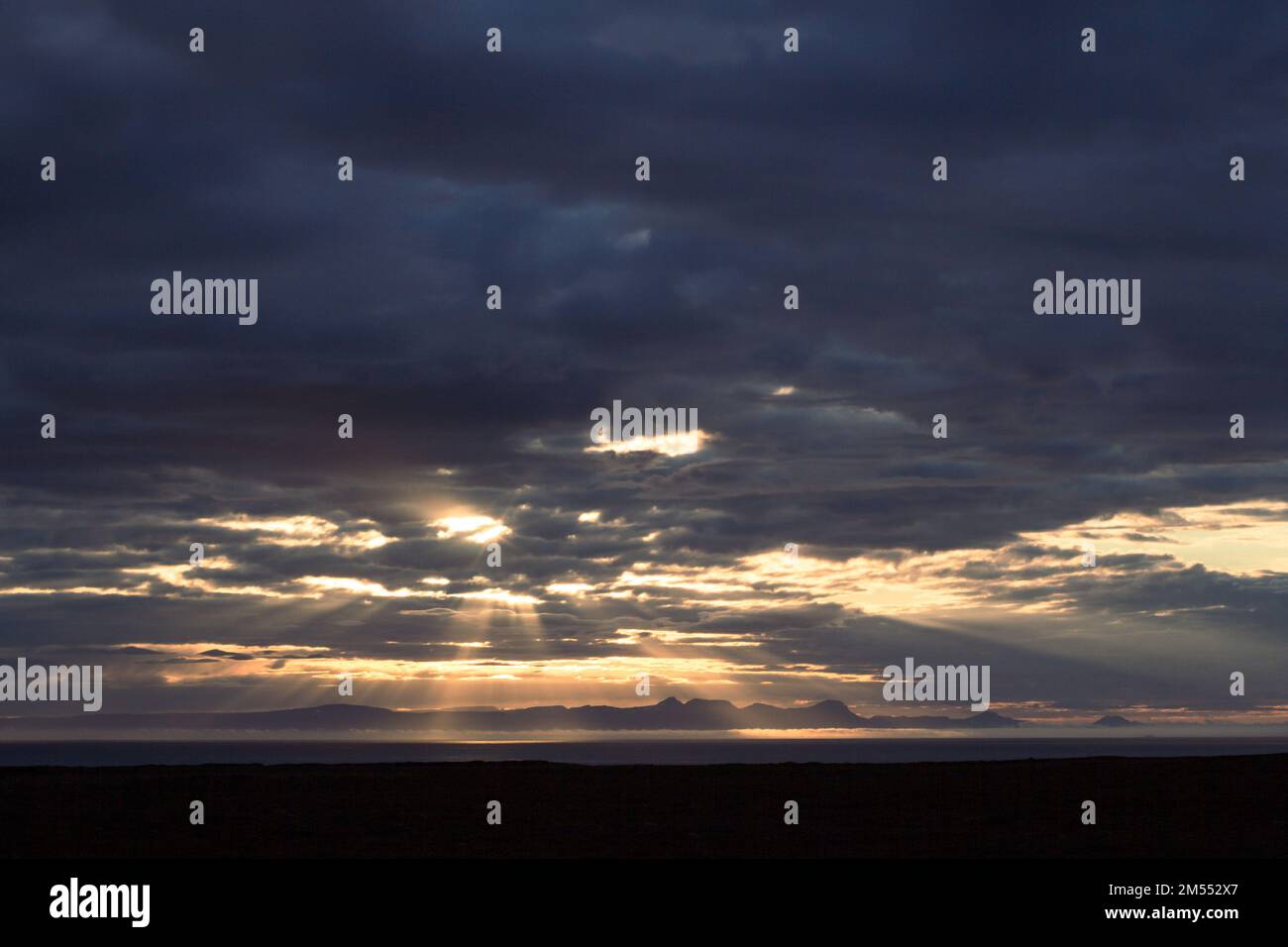 Sunbeams in clouds over valley landscape photo Stock Photo - Alamy