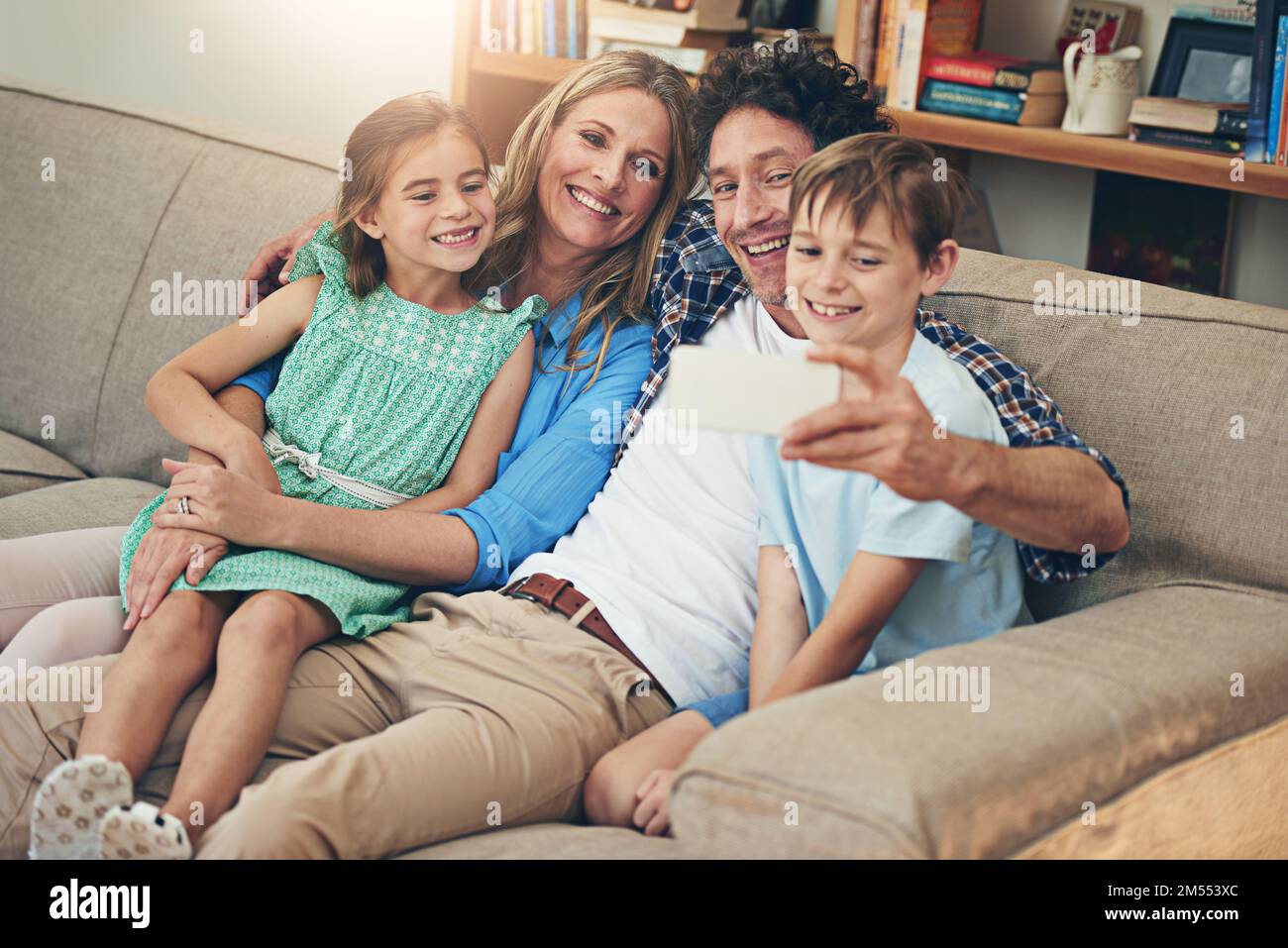 Taking selfies fam style. a happy family taking a selfie together on a ...
