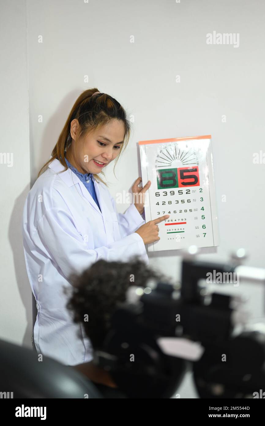 Shot of ophthalmologist checking child eyesight with ophthalmology ...