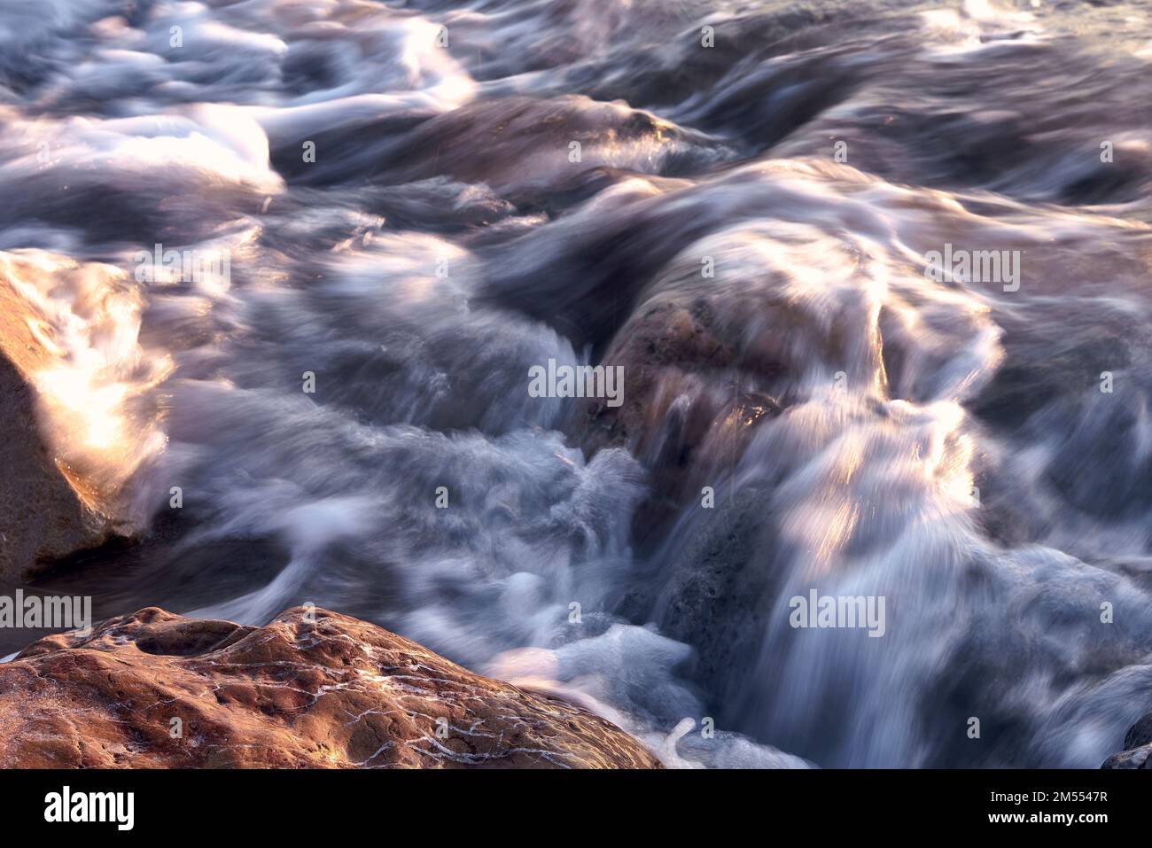 Line of stones from the coast at sunrise. Long exposure, silk effect ...