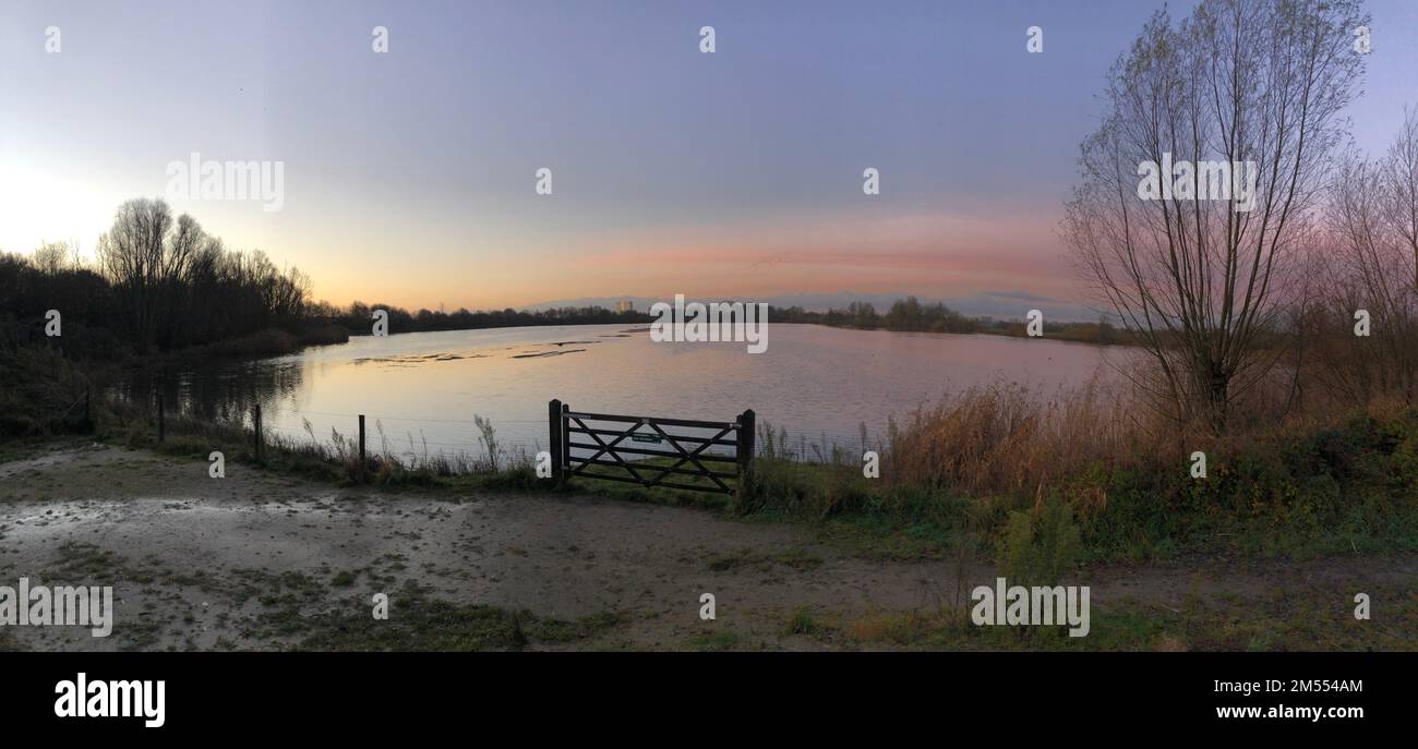 An aerial panoramic view from the lakeshore during pink and blue sunset ...