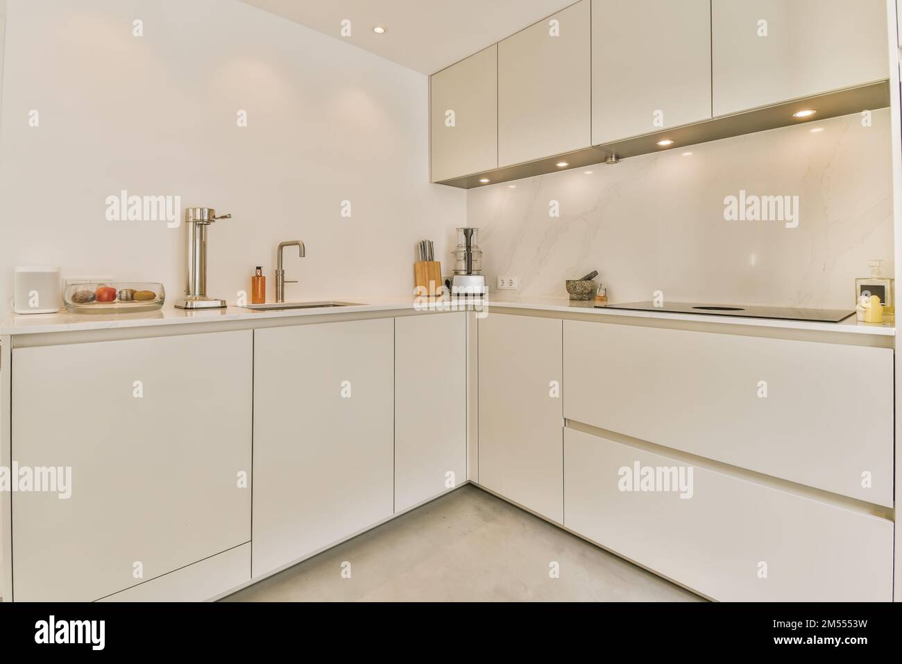 a kitchen with white cupboards and counter space in the center of the ...