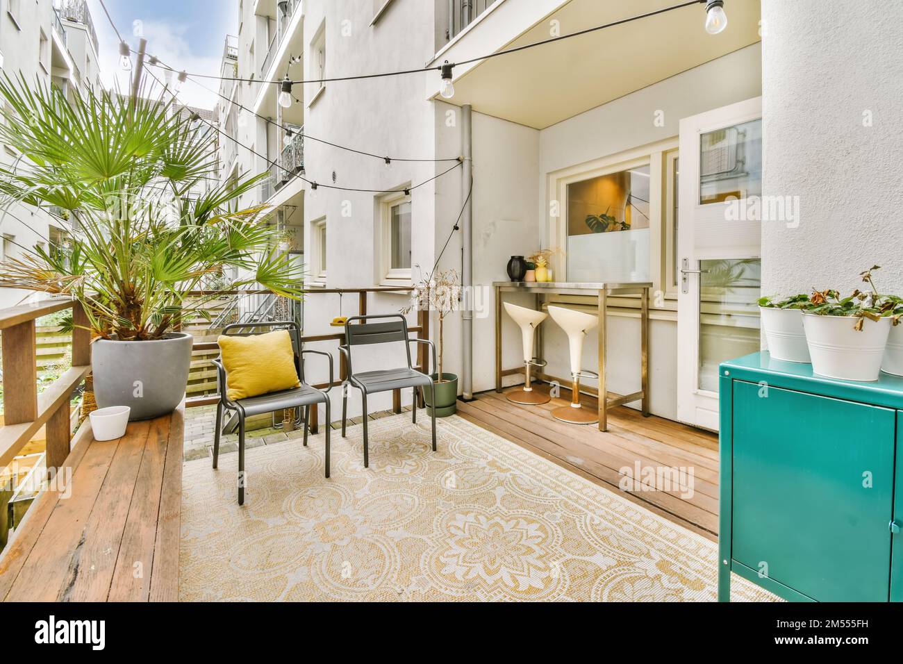 an outdoor living area with patio furniture and potted plants on the ...