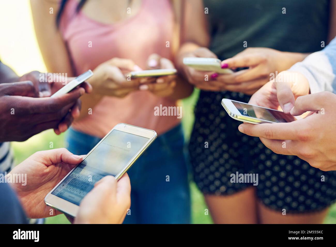 The age of the app. a group of friends using their phones together ...
