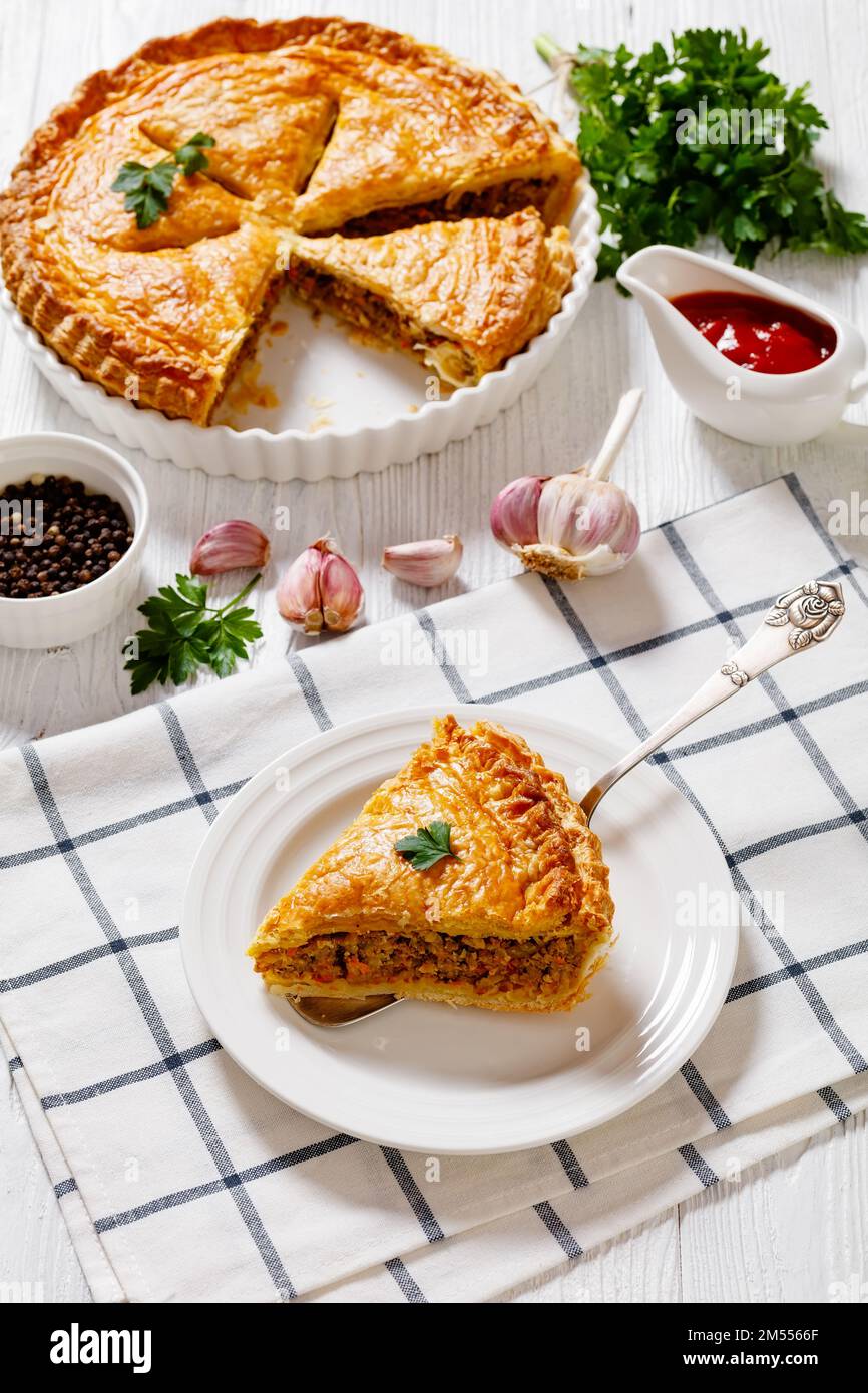 sliced Ground Beef Meat Pie with a flaky puff pastry double crust with ...