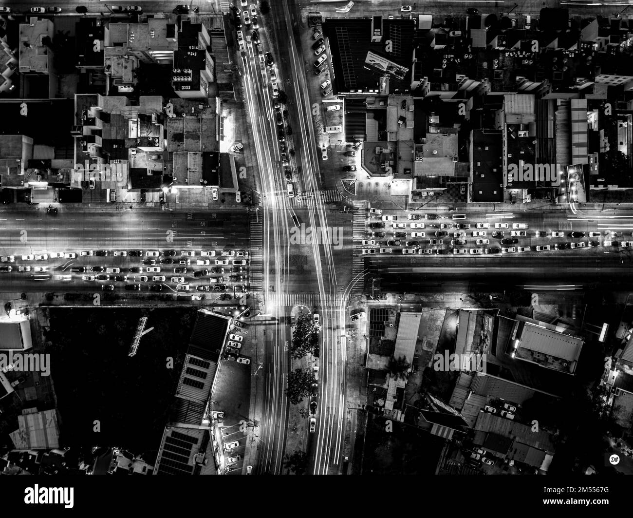 An aerial top view of a crossroad illuminated by traffic lights in a ...
