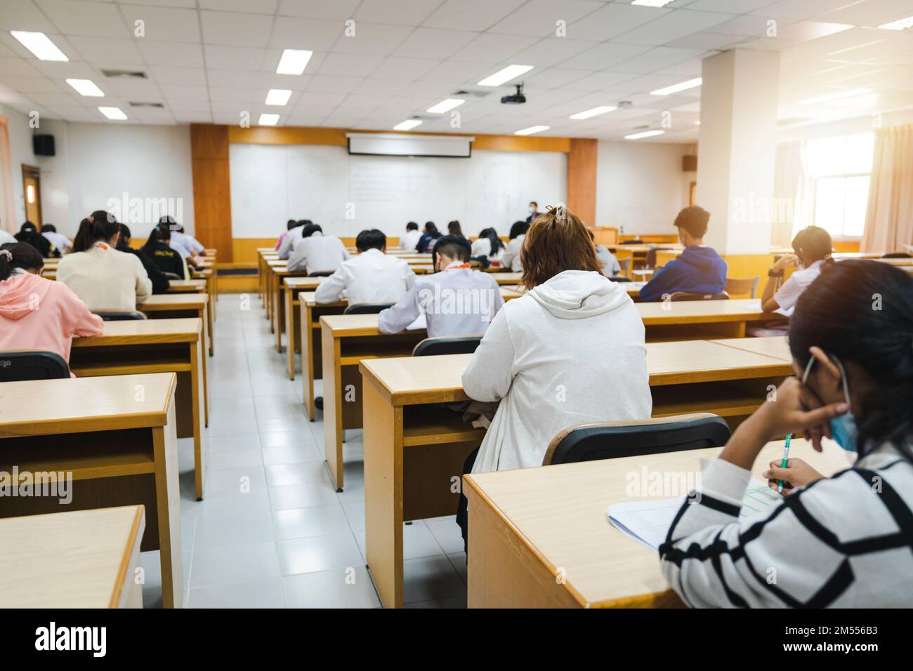 A view of students writing final examination papers in the classroom ...