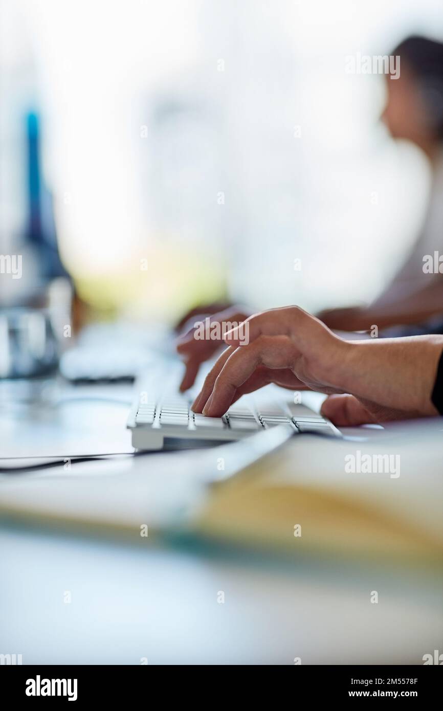 Typing towards a better future. a group of workers sitting at their ...