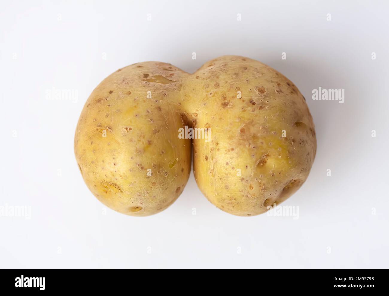 Raw funny potato in a shape of ass on white background Stock Photo - Alamy