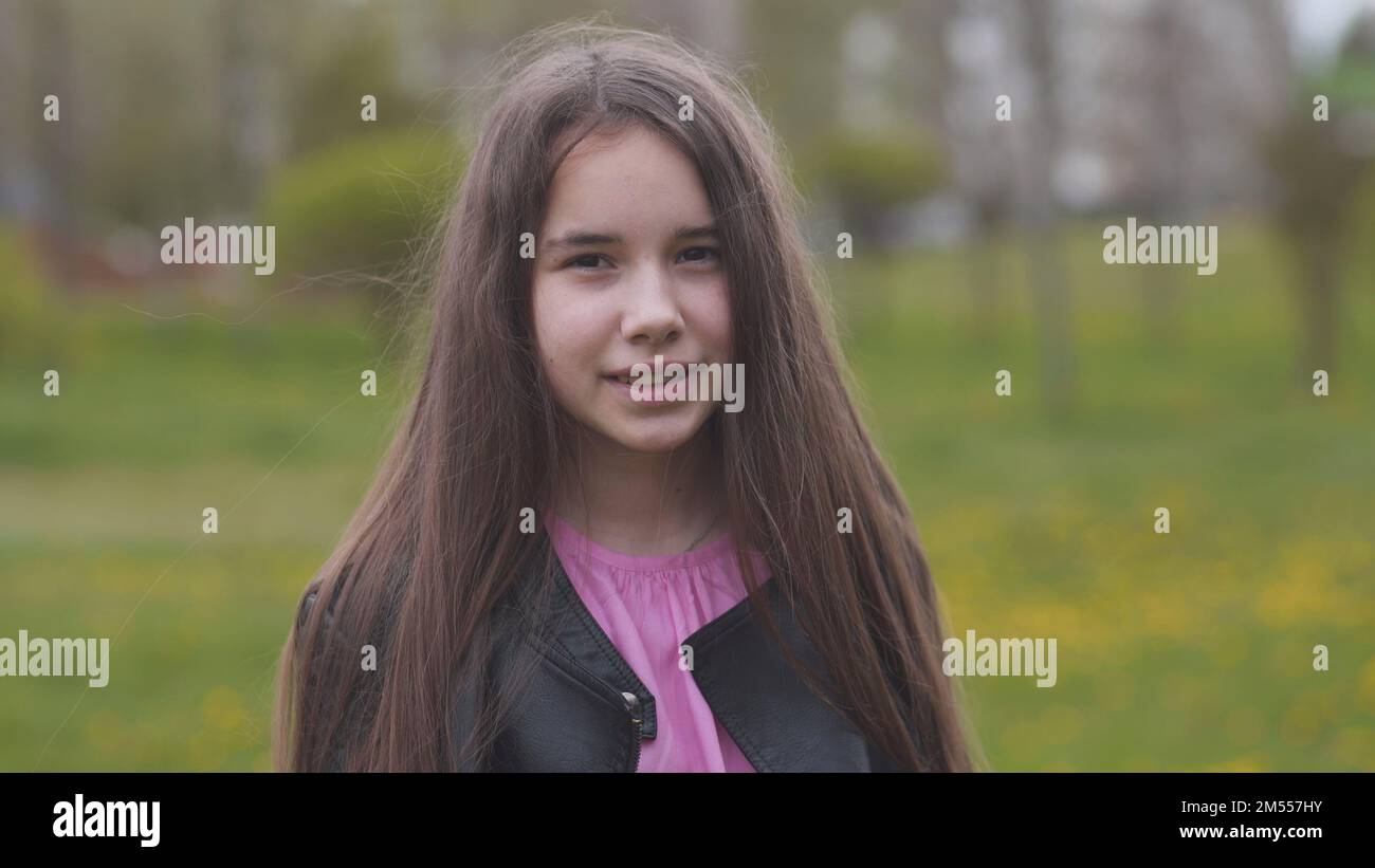 A teenage girl with long hair twirls and poses for the camera Stock ...