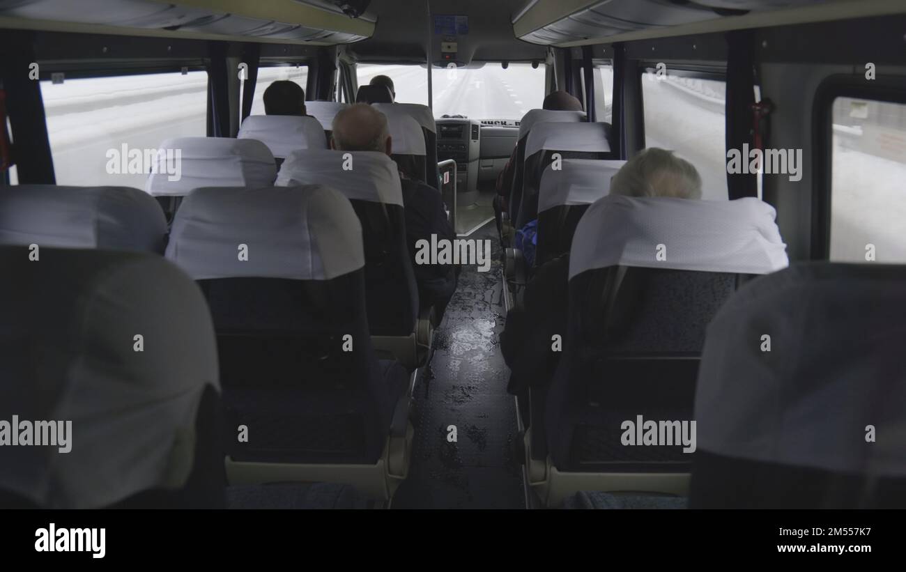 Minibus with passengers on the move in winter Stock Photo - Alamy