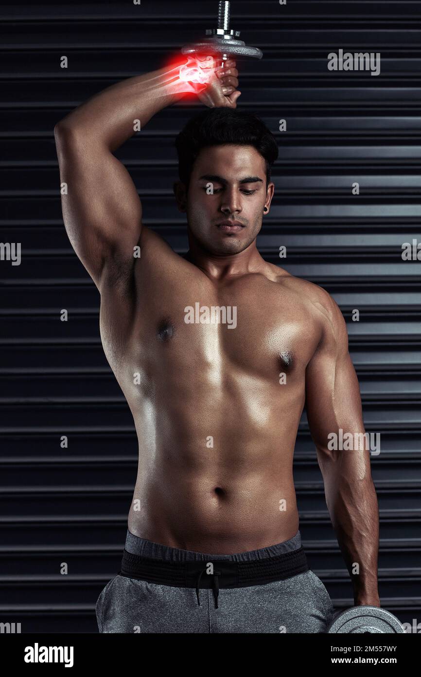 Pushing through the pain barrier. an athletic young man working out ...