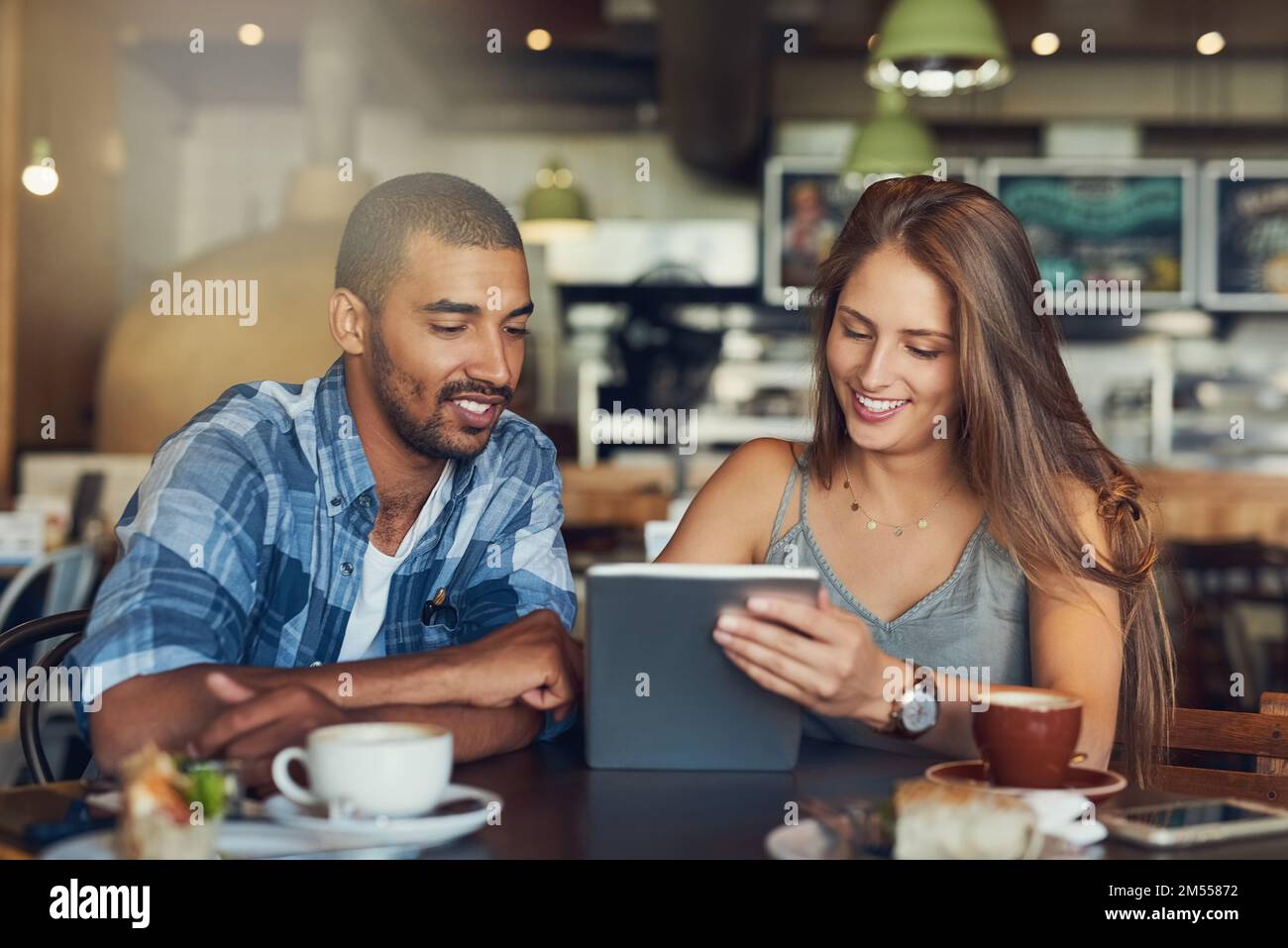 Young couple sitting inside restaurant hi-res stock photography and ...
