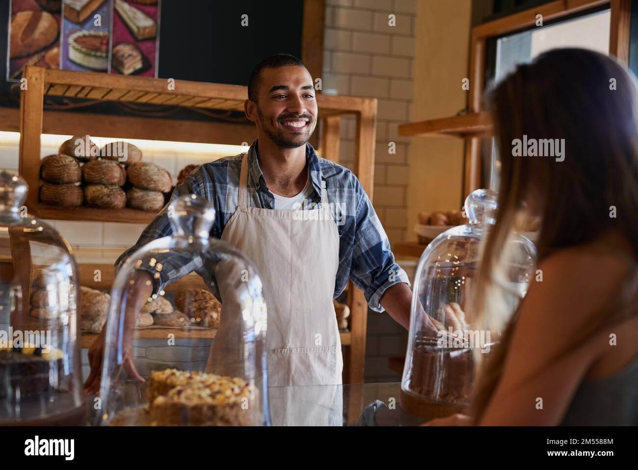 Can I interest you in our special of the day. a shop assistant serving ...
