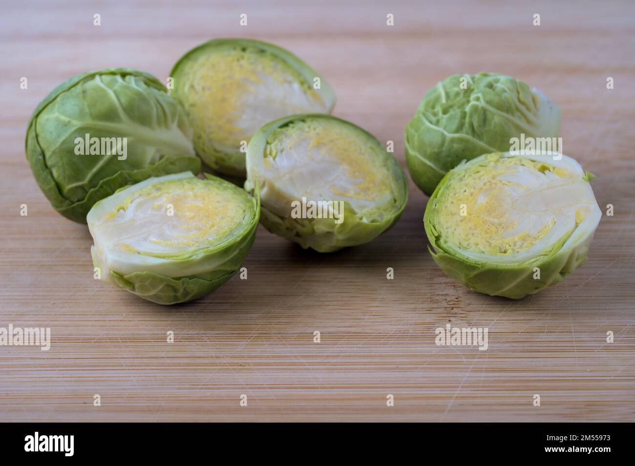 brussels sprouts ready for cooking isolated on a wooden background ...
