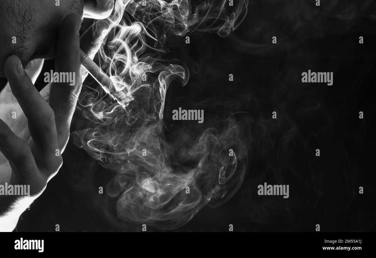 Smoke and choke. Cigarette smoke dark background. Steaming cigarette in ...