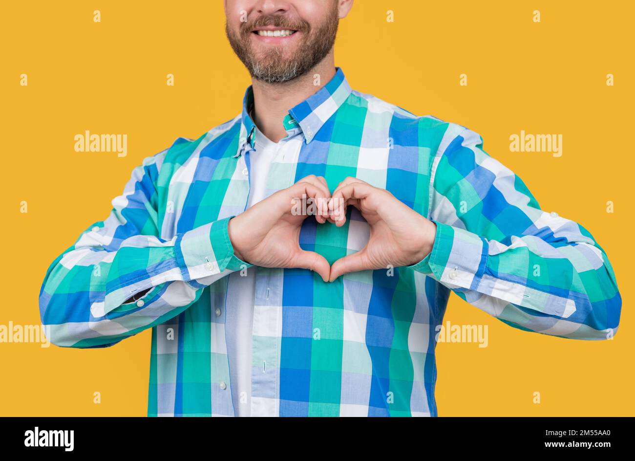 cropped view of man gesturing love heart. bearded caucasian man in ...