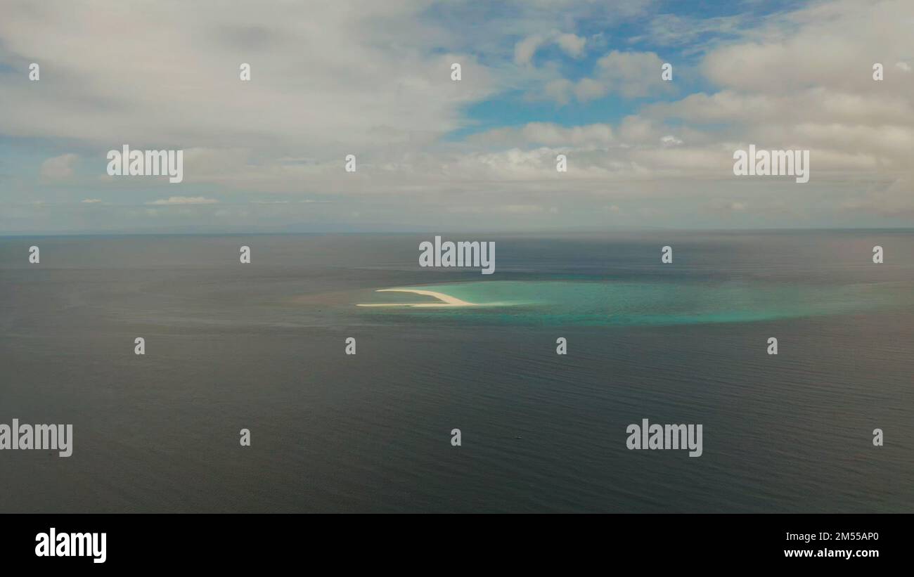 Tropical white island and sandy beach with tourists surrounded by coral ...