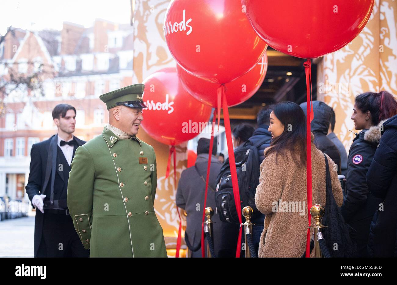 EDITORIAL USE ONLY Arnie Bade greeting customers queuing outside ...