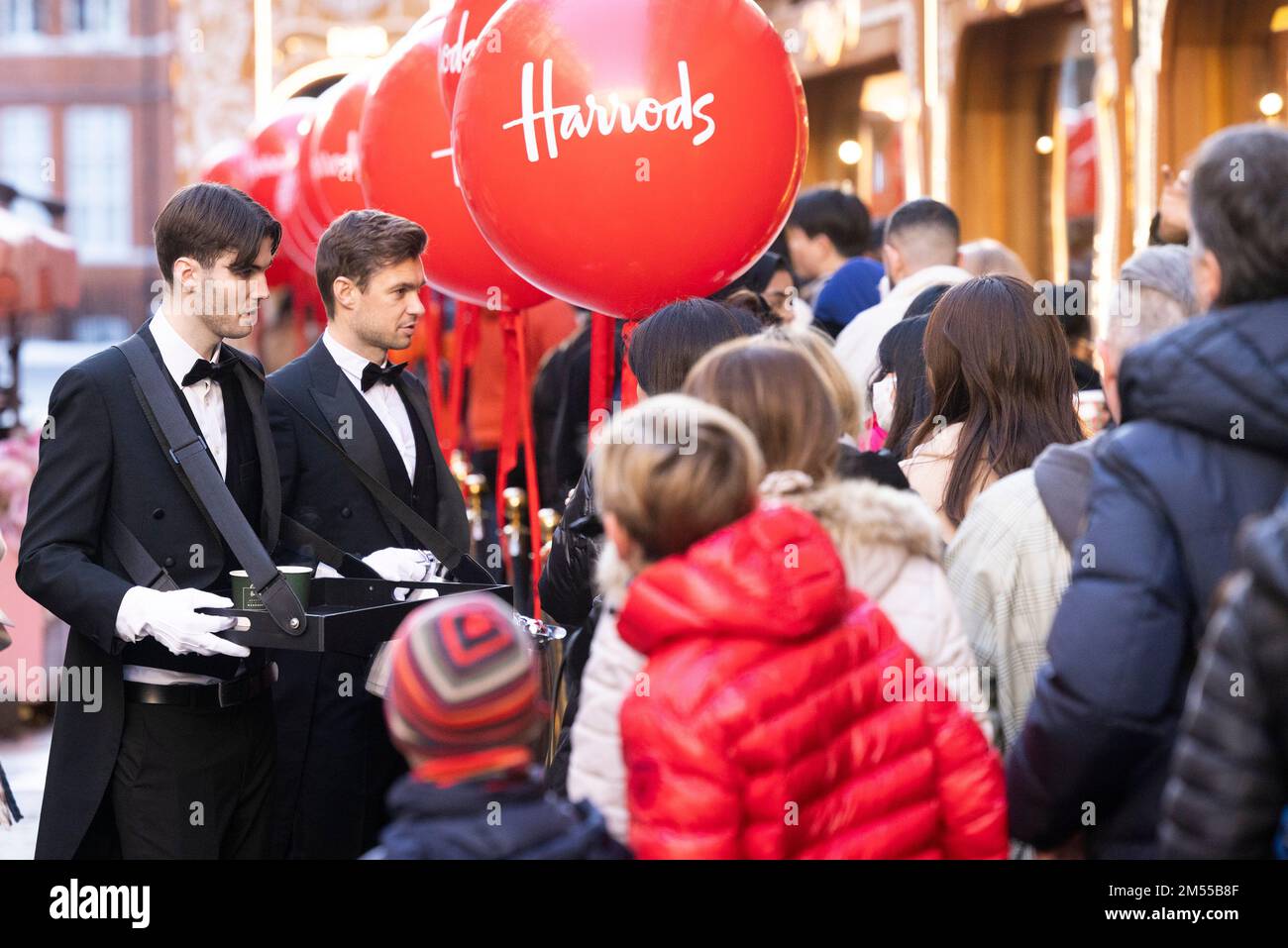 EDITORIAL USE ONLY Employees offer refreshments to customers queueing ...