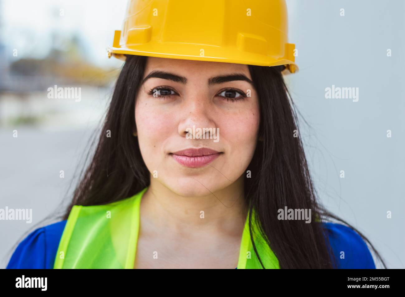 portrait of young venezuelan engineer latina woman, with yellow safety ...