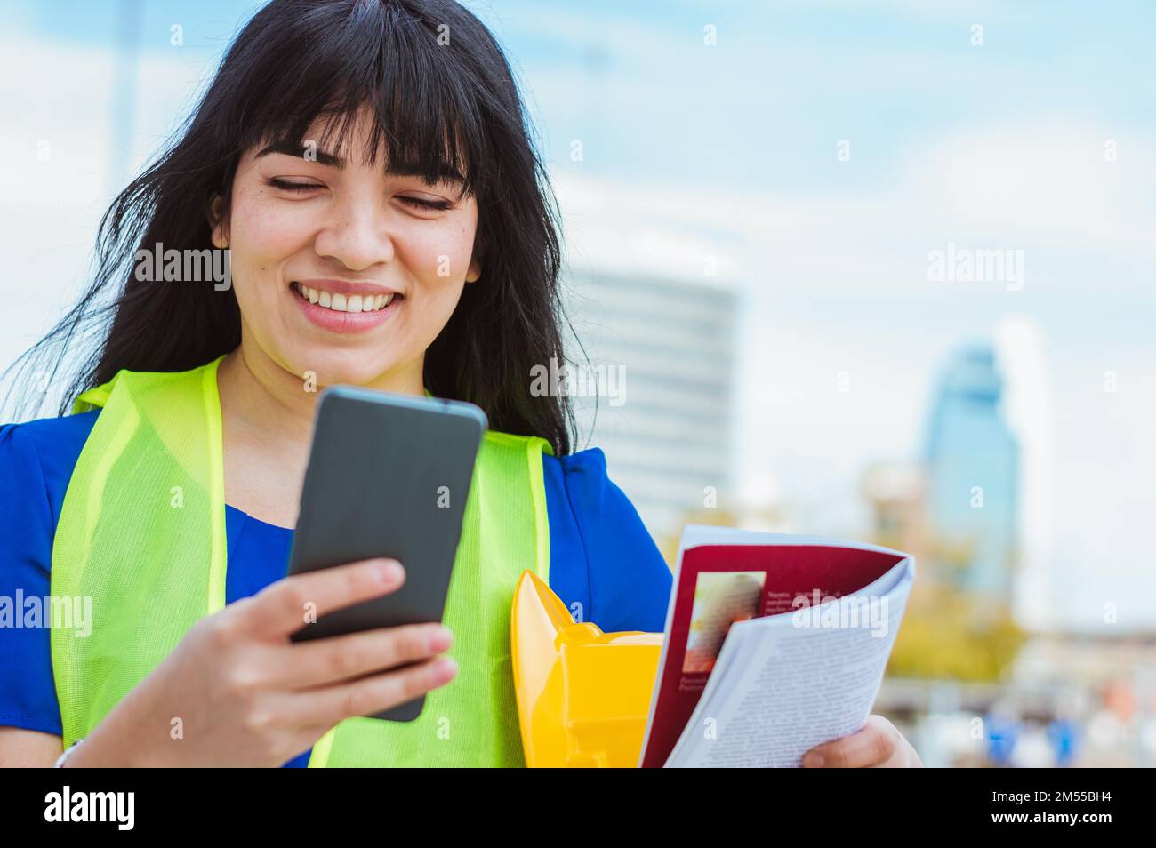 closeup of latin young female engineer on her lunch break, smiling ...