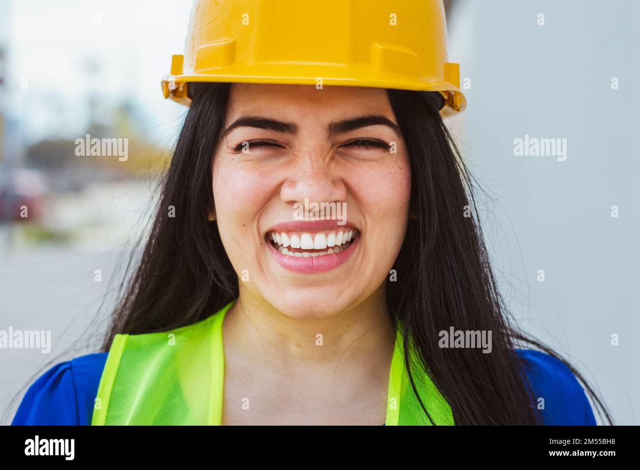 front view closeup portrait of happy young female engineer smiling with ...