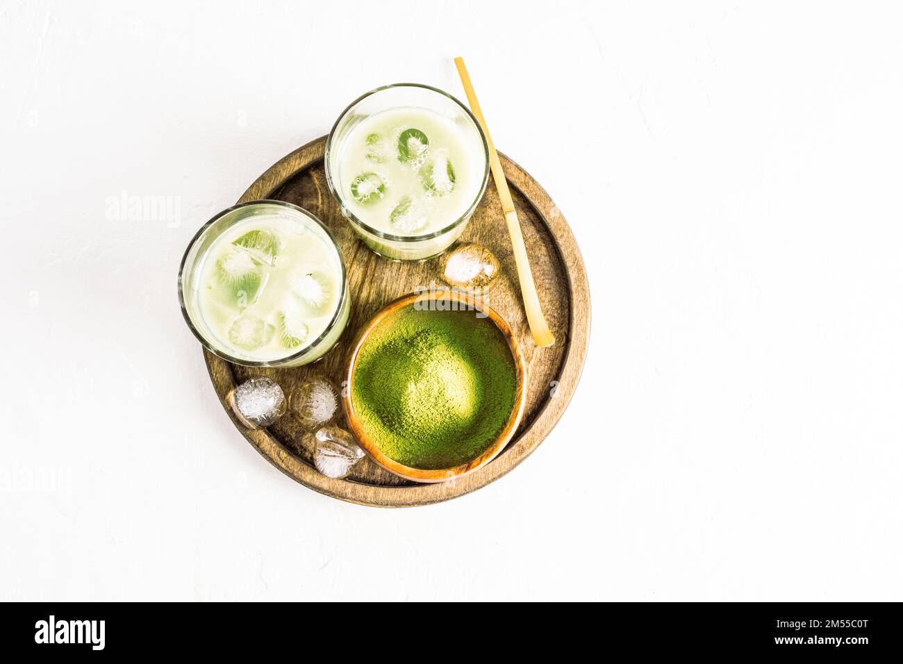 Green matcha tea drink and tea accessories on white background ...