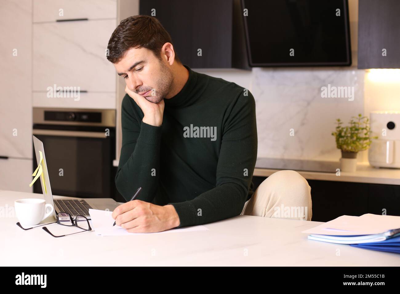 Man writing with pen and paper in home office Stock Photo - Alamy
