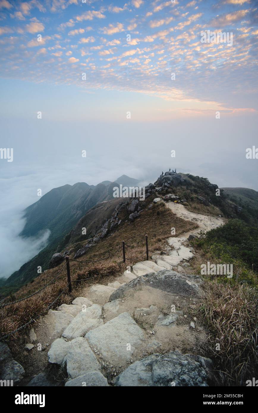 A vertical shot of a narrow walkway on top of the big mountains with ...