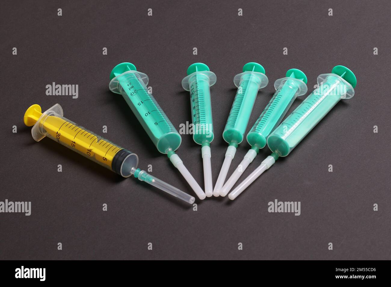 Top view of medical syringes with needles at black background with copy ...