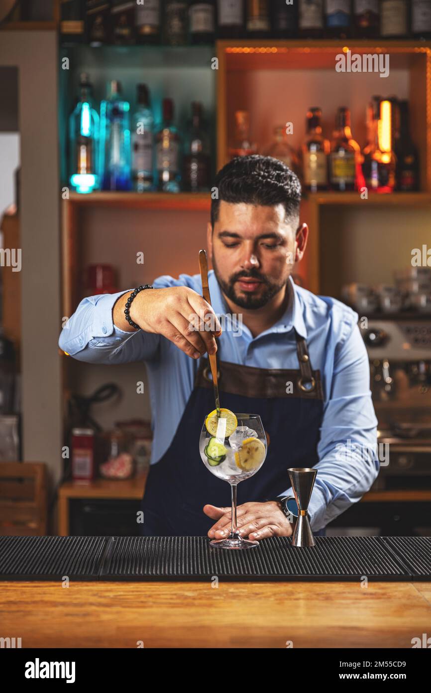 Bartender preparing delicious cocktail in bar counter Stock Photo - Alamy