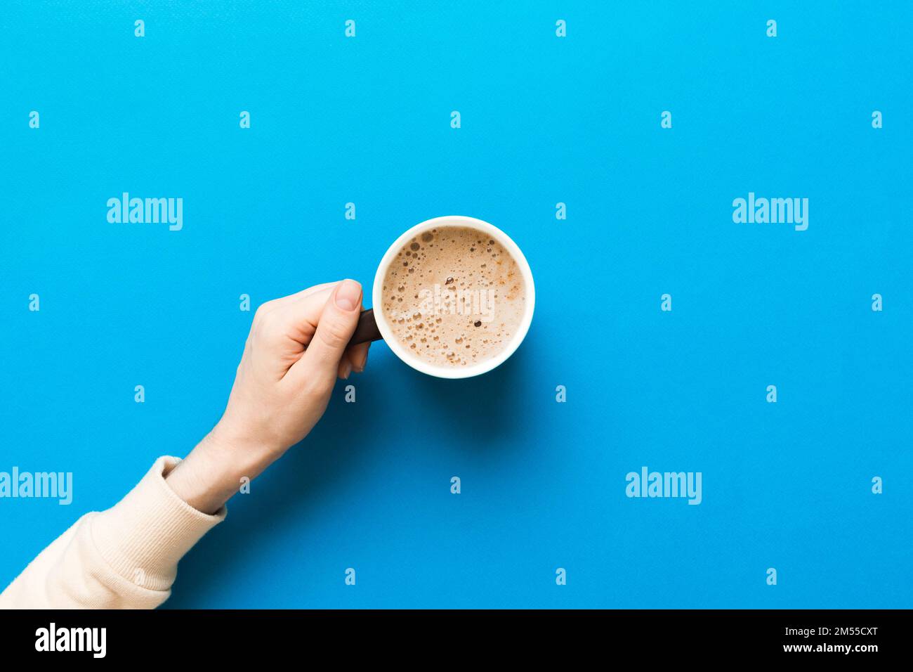 Minimalistic style woman hand holding a cup of coffee on Colored ...