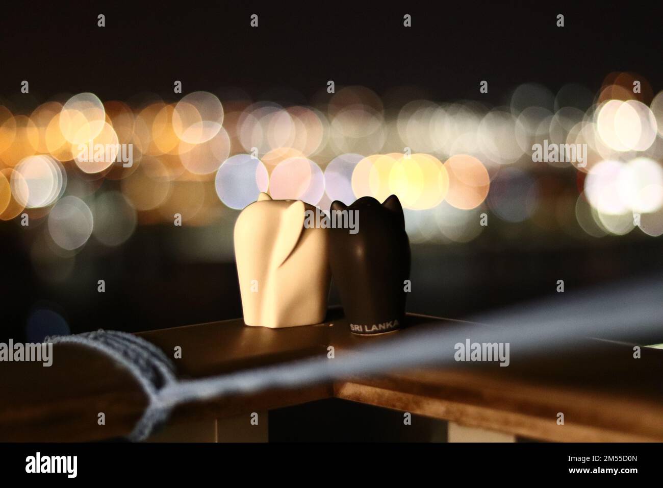 A selective focus of cute elephant figurines on a wooden surface with a ...