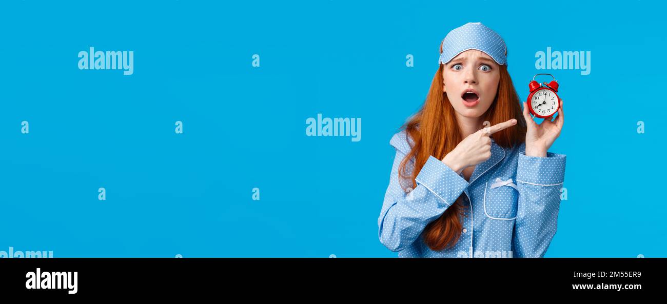 Upset and disappointed gloomy redhead woman in nightwear. sleep mask ...
