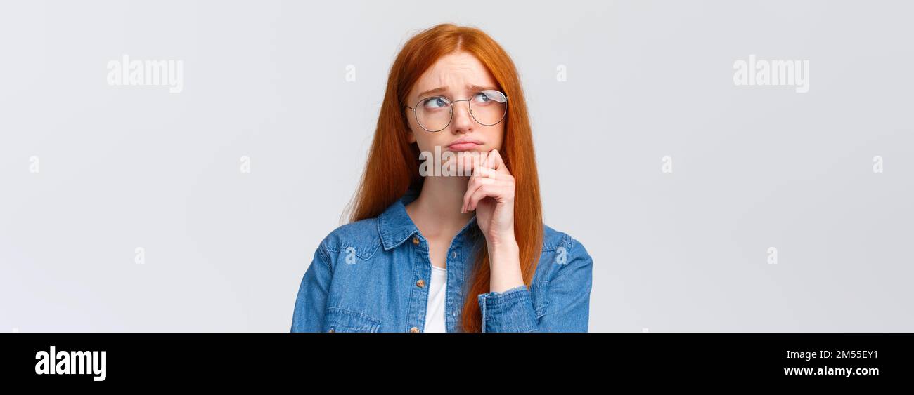 Uneasy sulky cute timid redhead college girl in glasses, look up ...